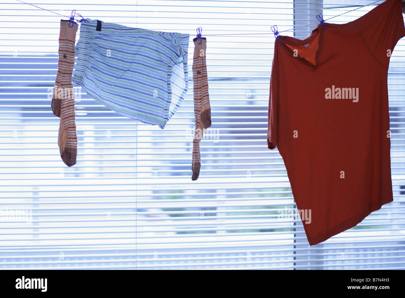Clothes Hanging By Window Stock Photo - Alamy