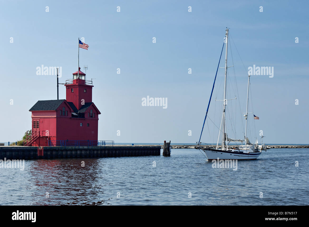 Sailboat Motoring Past the Holland Harbor Lighthouse on Lake Michigan ...