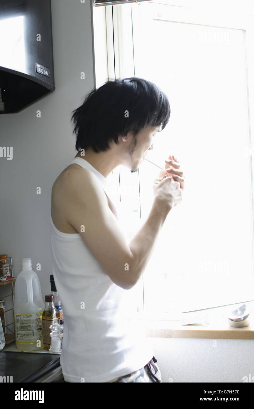 Man Smoking By Window Stock Photo - Alamy