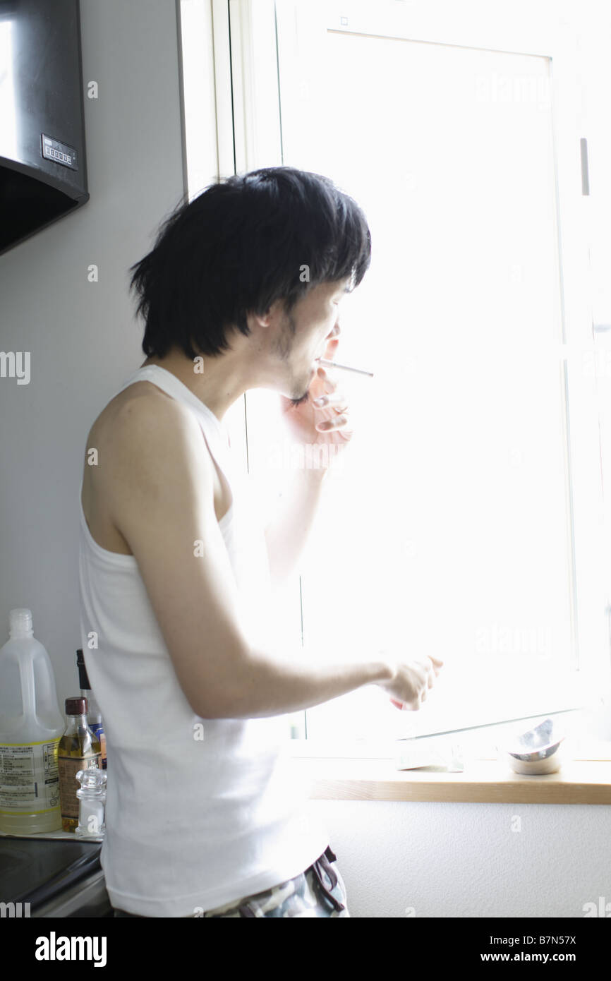 Man Smoking By Window Stock Photo - Alamy