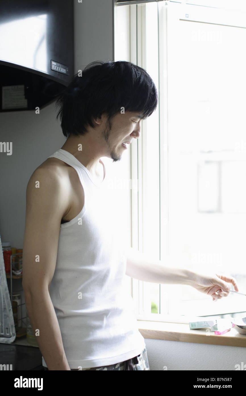 Man Smoking By Window Stock Photo - Alamy