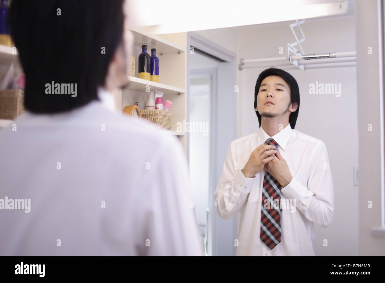Man Adjusting His Tie Stock Photo - Alamy