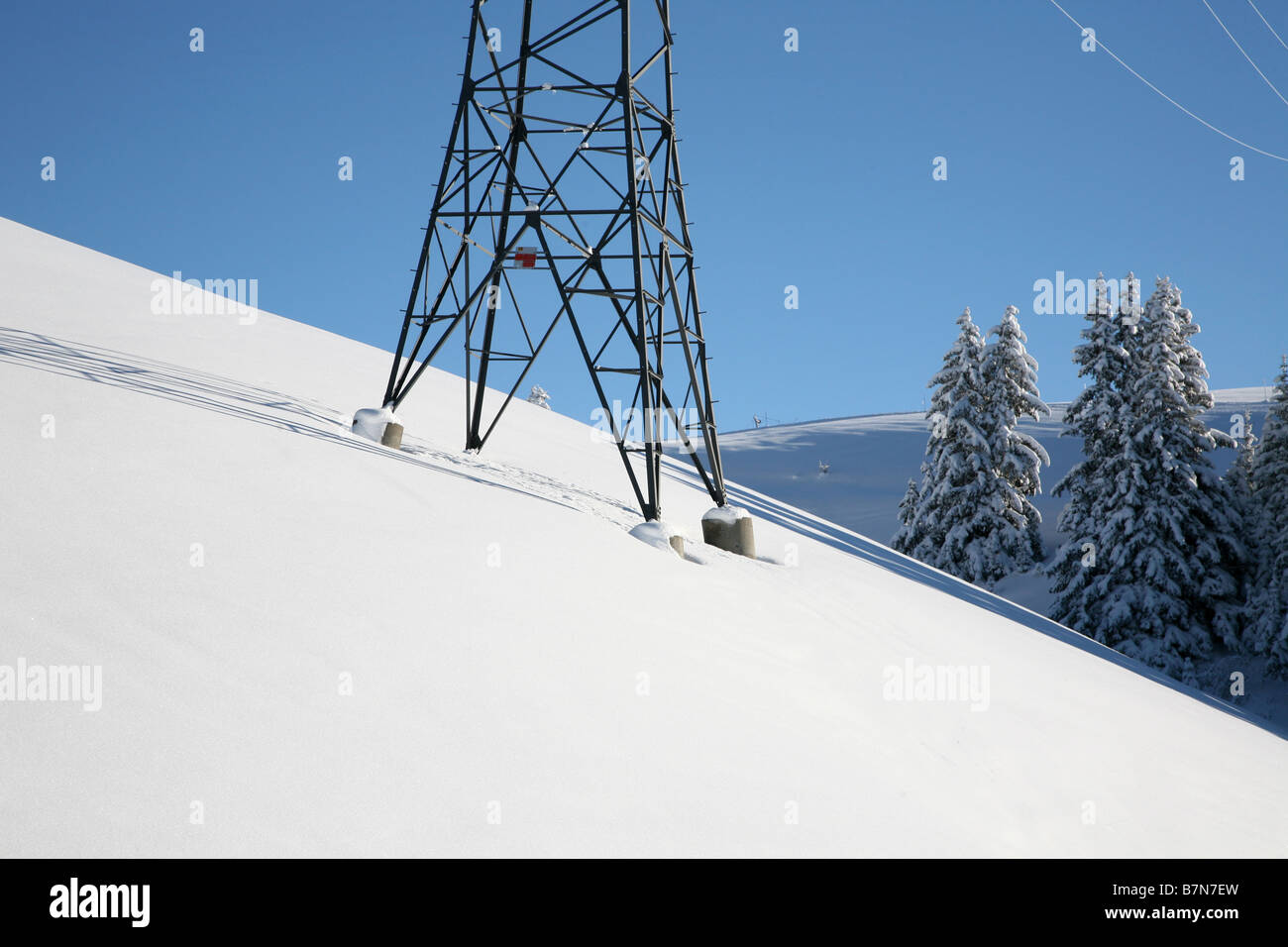 Pylon in the snow Stock Photo - Alamy