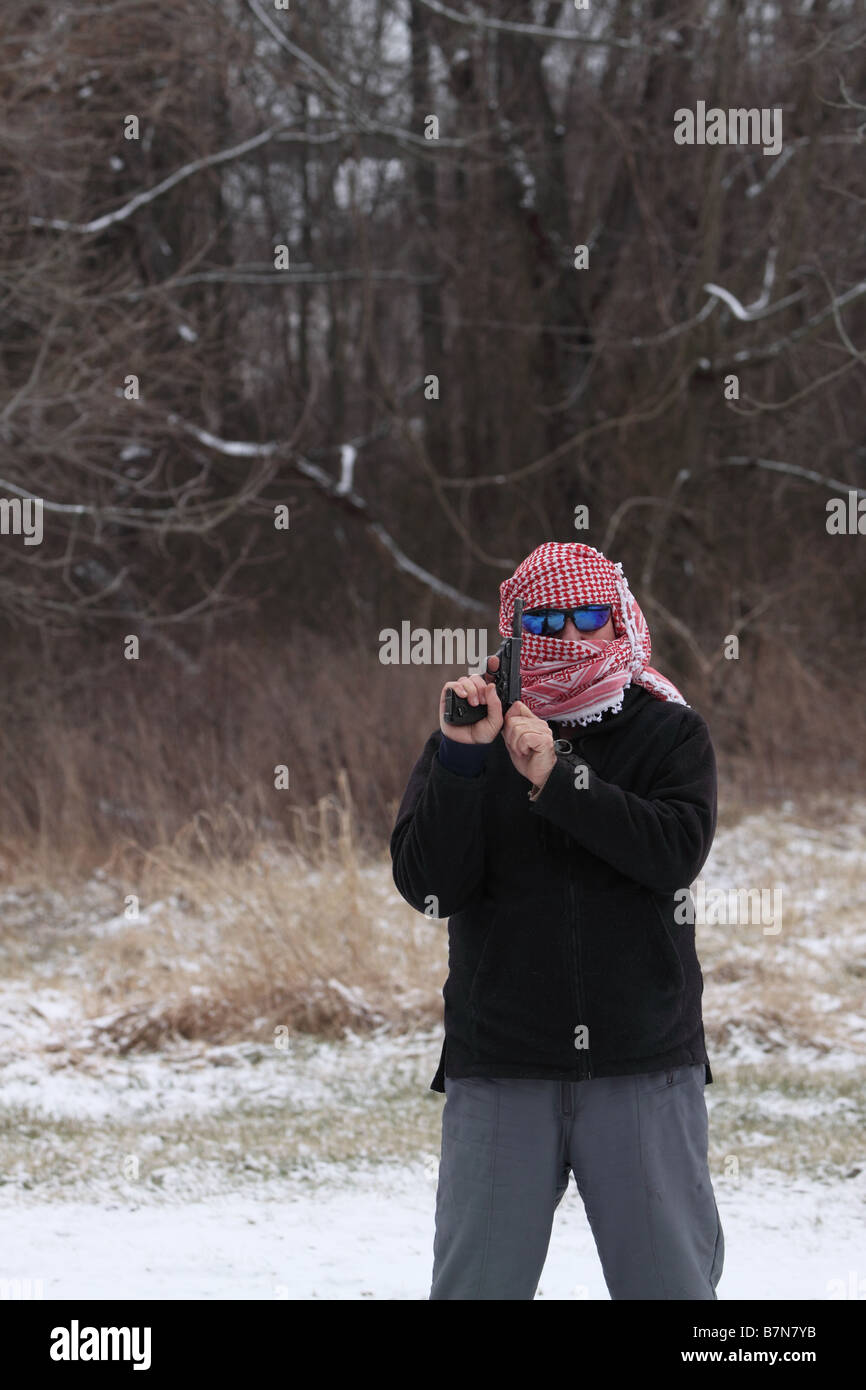 terrorist pointing gun and a hand grenade in a middle eastern headwrap ...