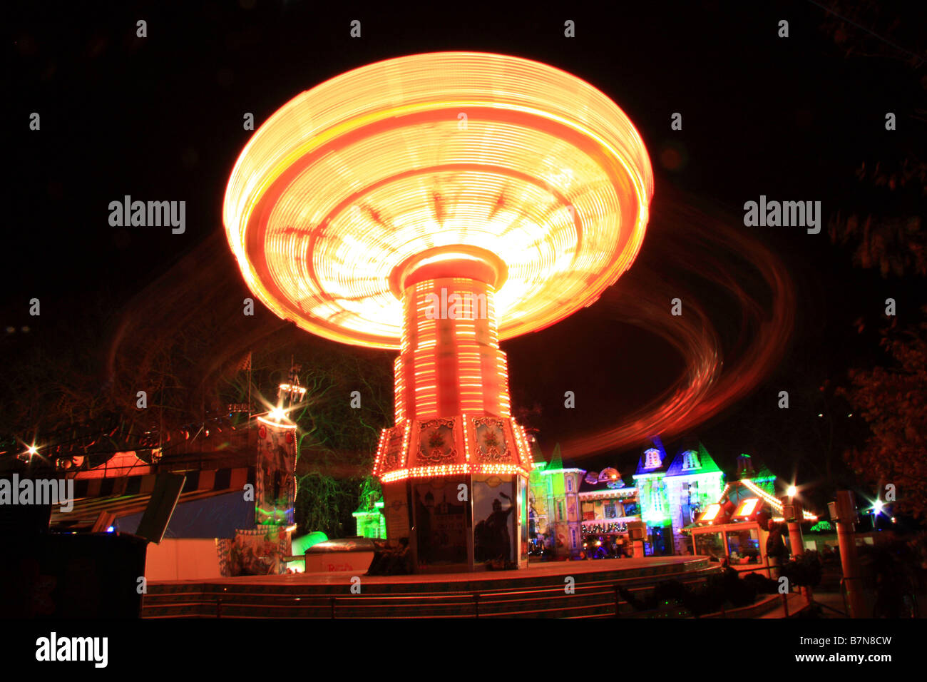 Illuminated traditional chained seat merry go round fairground ride ...