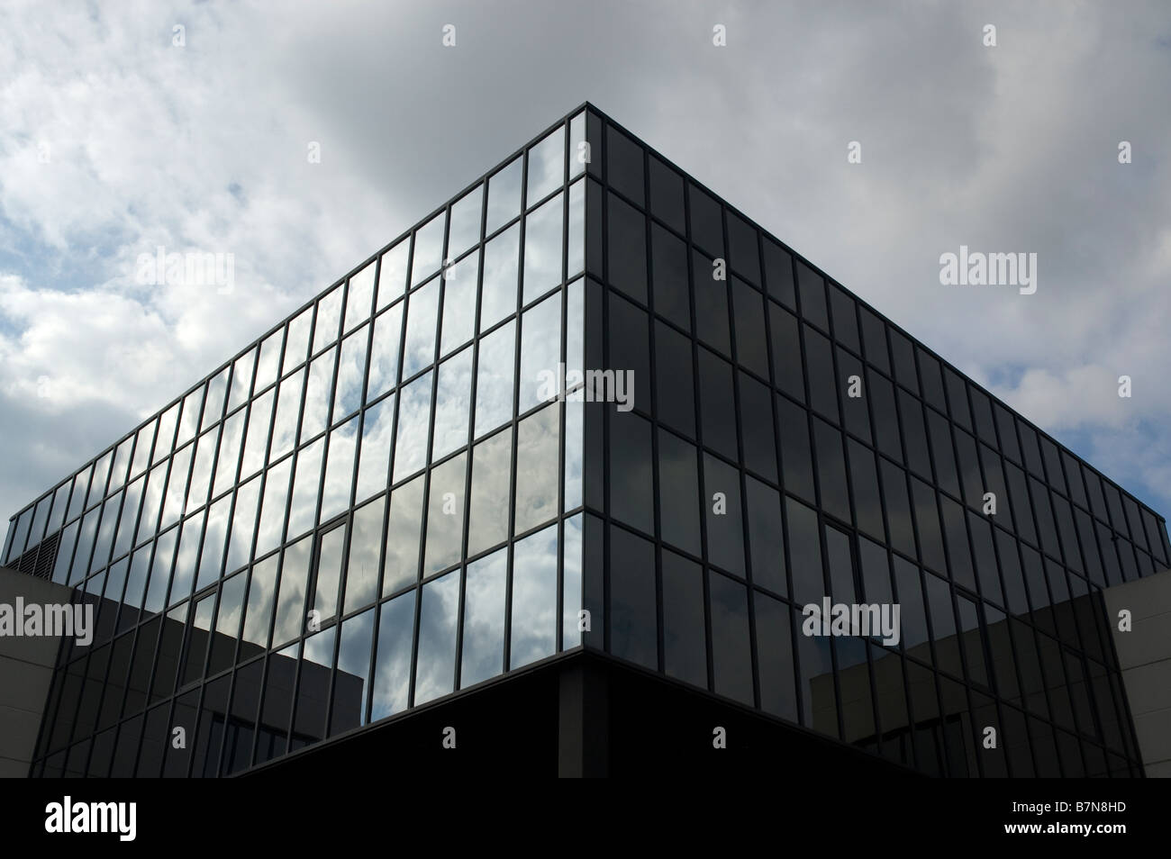 Office building with a dramatic stormy sky Stock Photo - Alamy