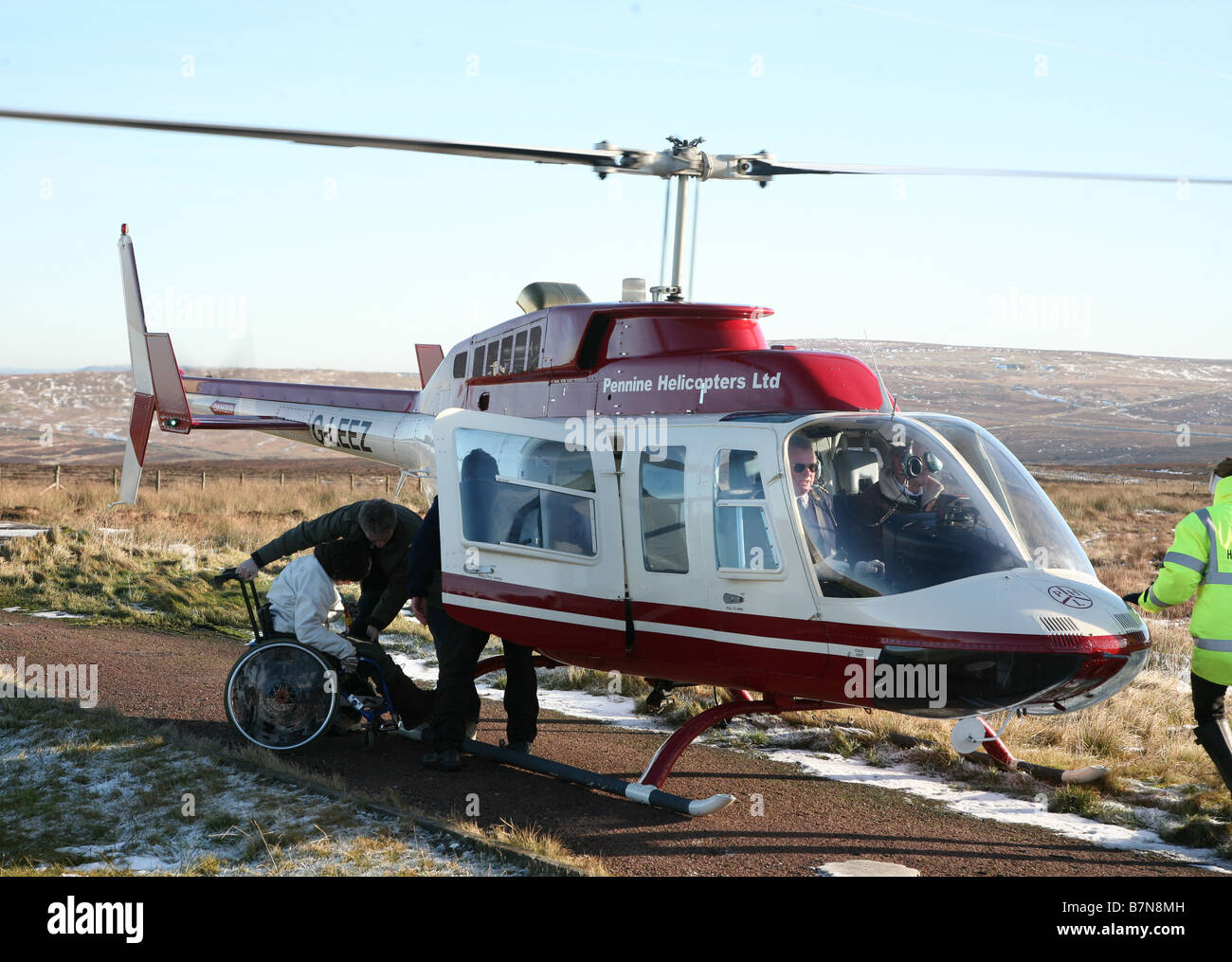 A pleasure helicopter with a young disabled person in a wheelchair ...