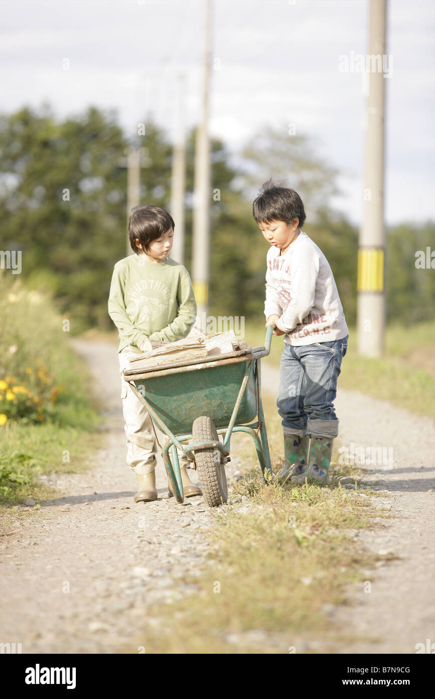 Boys wheeling the cart Stock Photo - Alamy