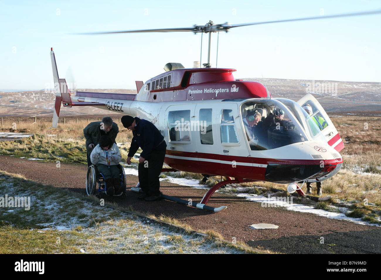 A pleasure helicopter with a young disabled person in a wheelchair ...