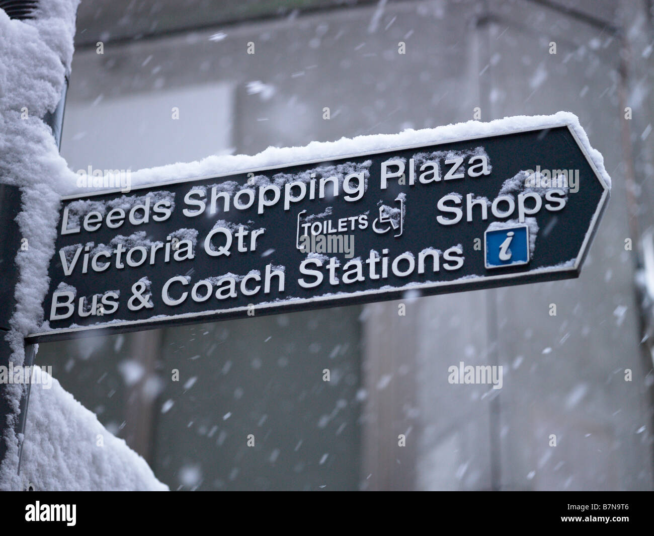 Snow covered signpost in Leeds city centre Stock Photo - Alamy