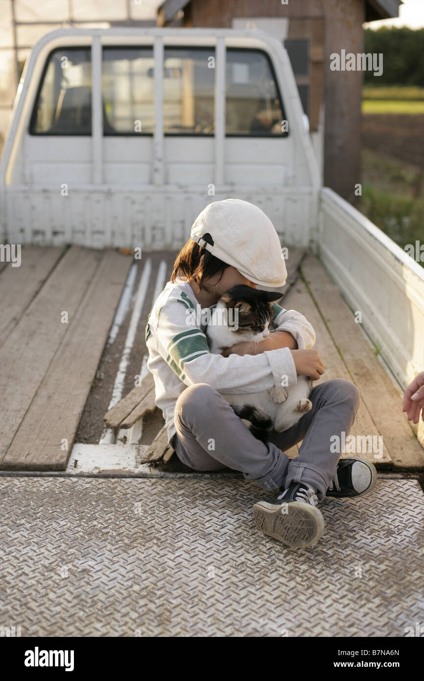 A boy holding the cat Stock Photo - Alamy