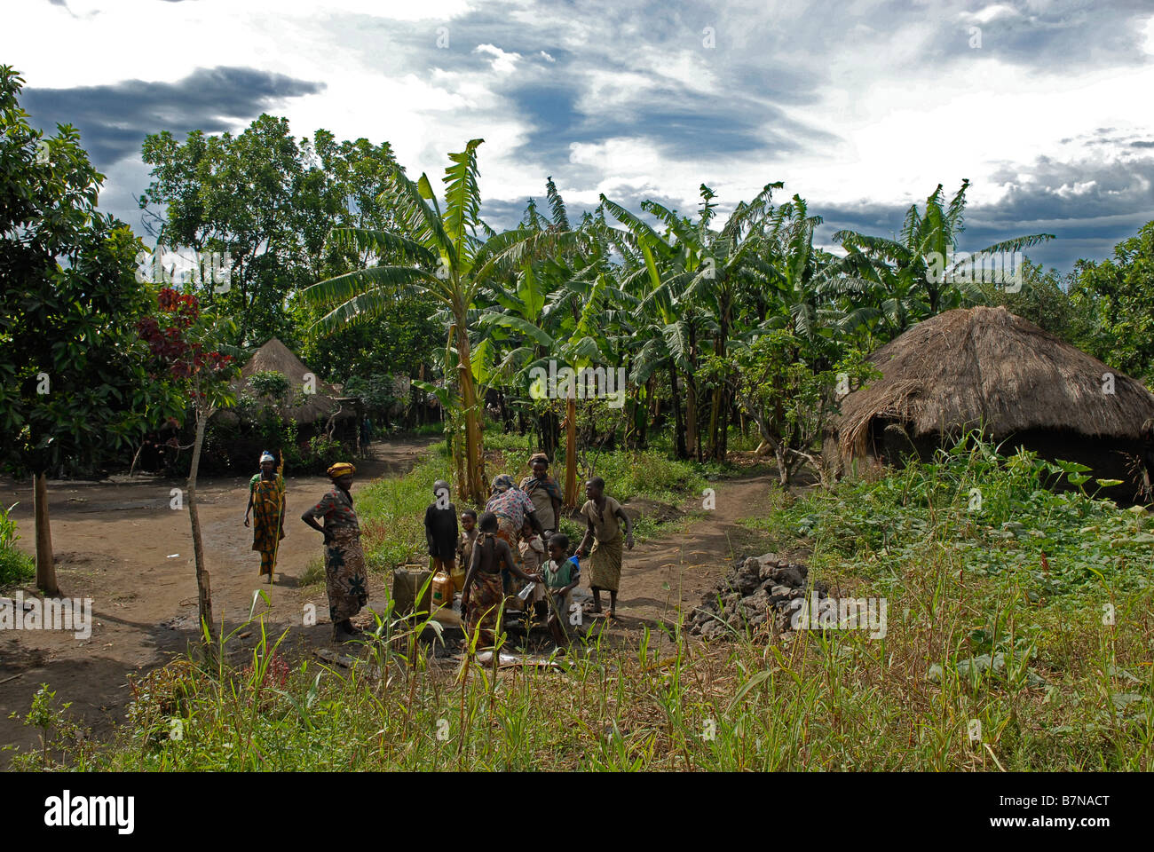 Congolese women stand amid straw huts in a rural settlement in North ...