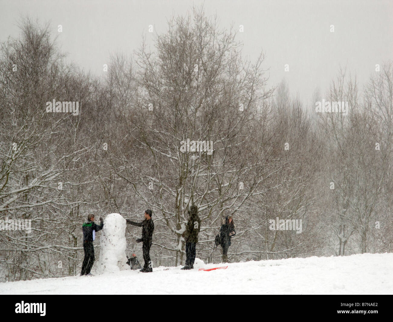 Children Building A Snowman High Resolution Stock Photography and ...
