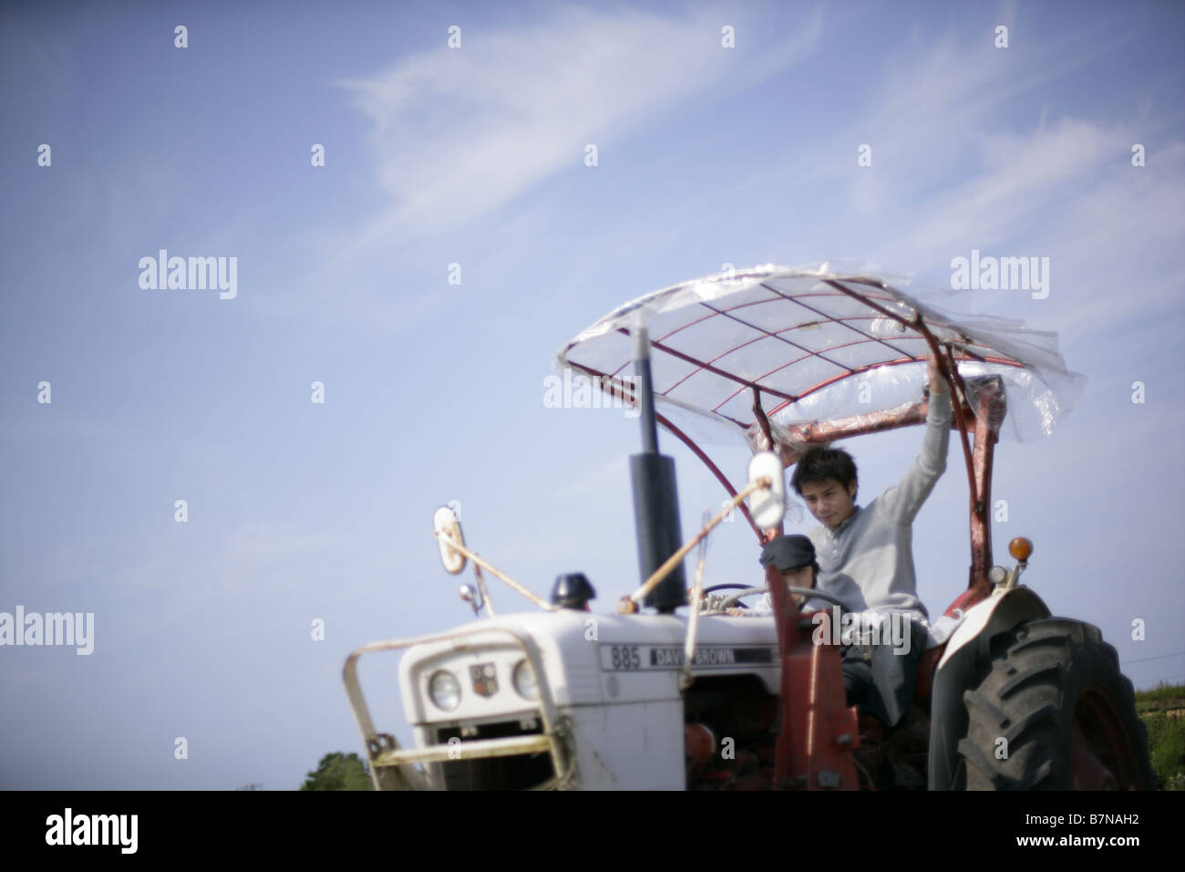 Boys driving tractor hi-res stock photography and images - Alamy