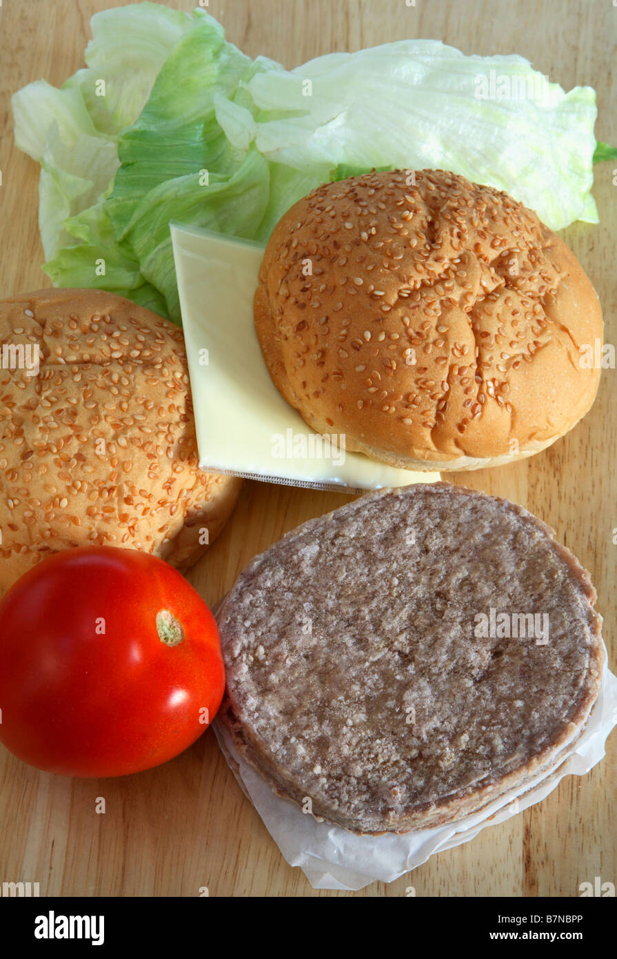 The ingredients for constructing a burger beef patty tomato lettuce ...