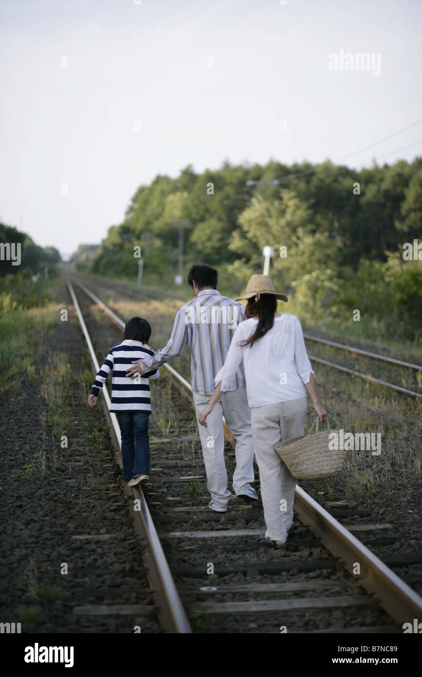 A family following the railway track Stock Photo - Alamy