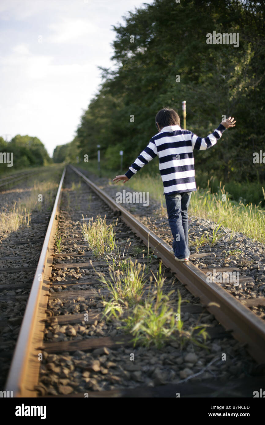 A boy following the railway track Stock Photo - Alamy