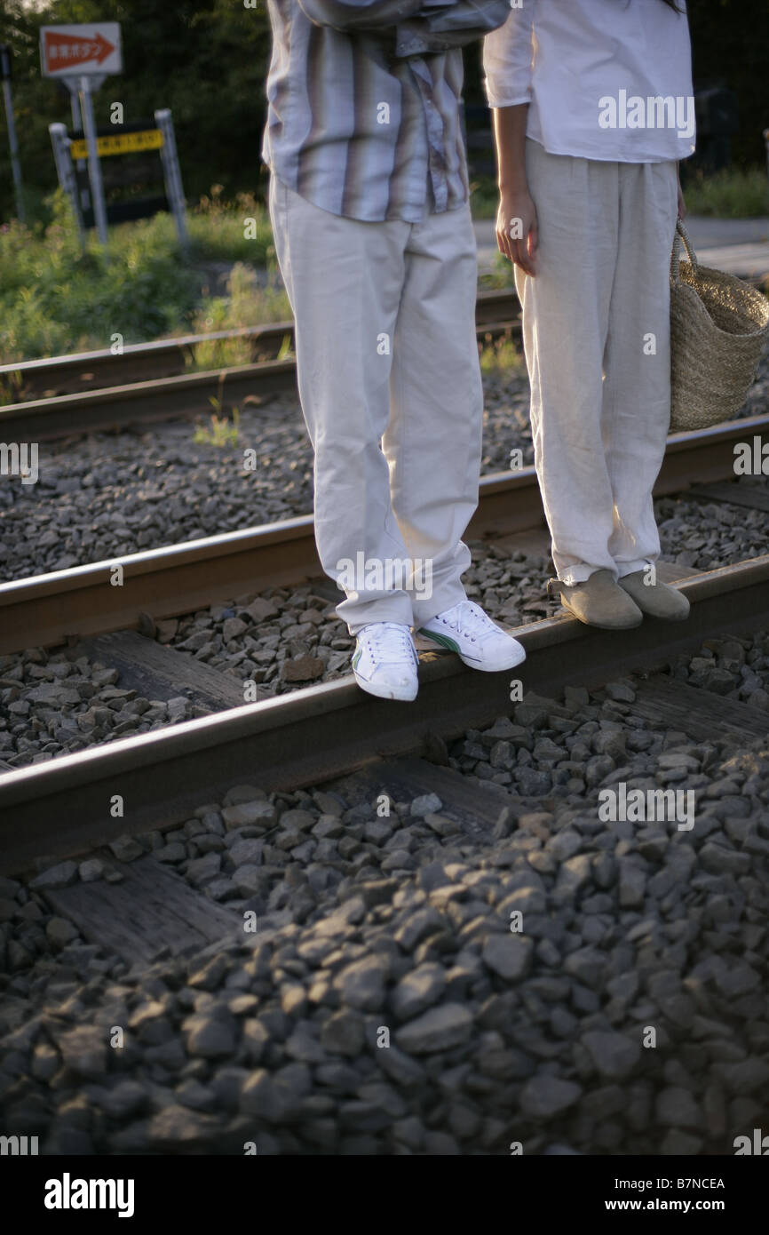 A couple standing on the railway track Stock Photo - Alamy