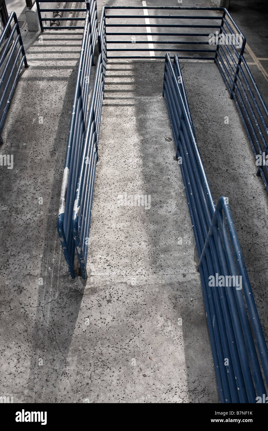 A cement ramp with blue railings Stock Photo - Alamy