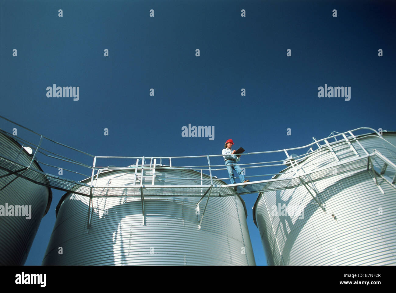 worker at grain storage silos Stock Photo - Alamy