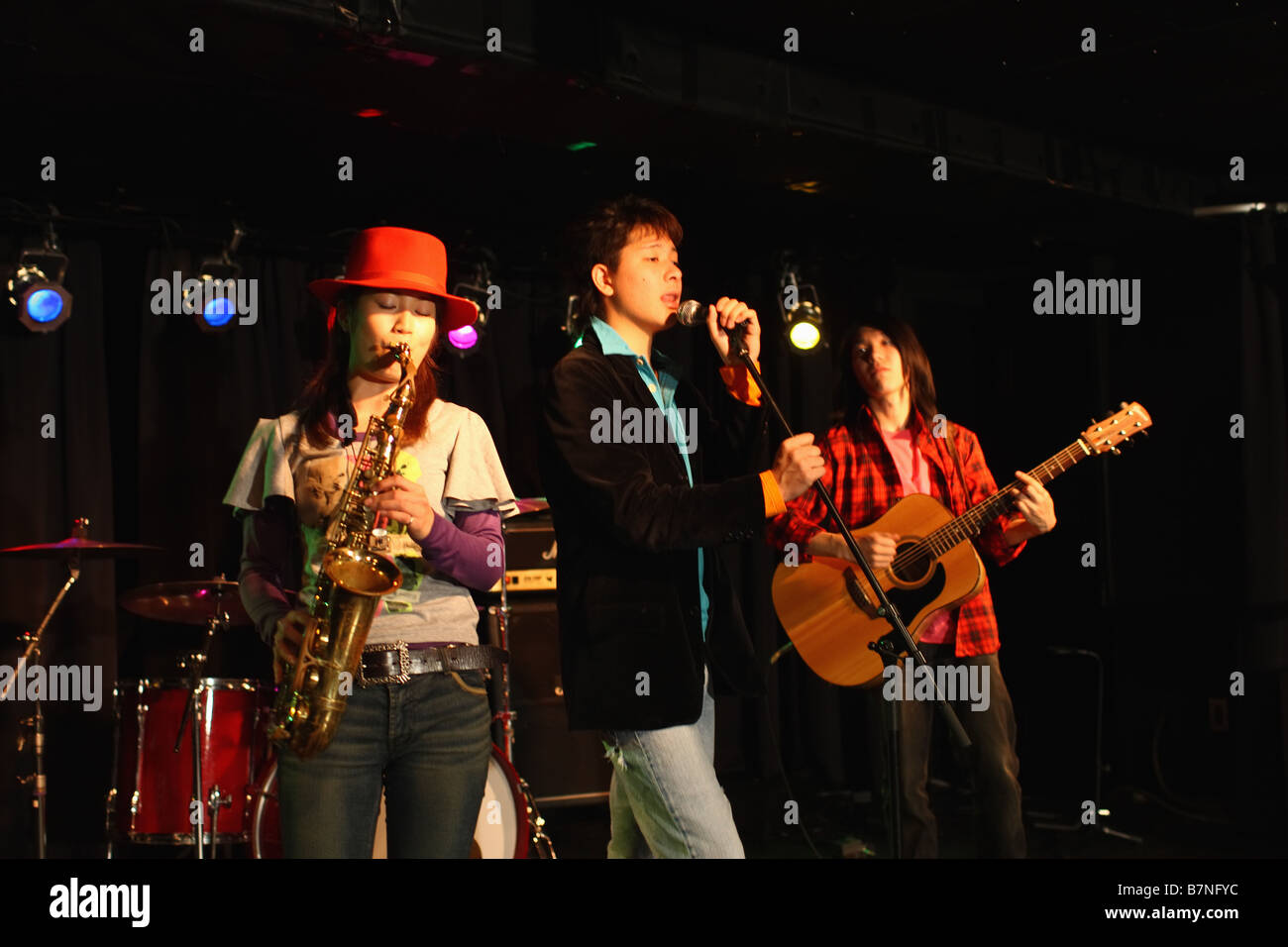Young people playing instruments on the stage Stock Photo - Alamy