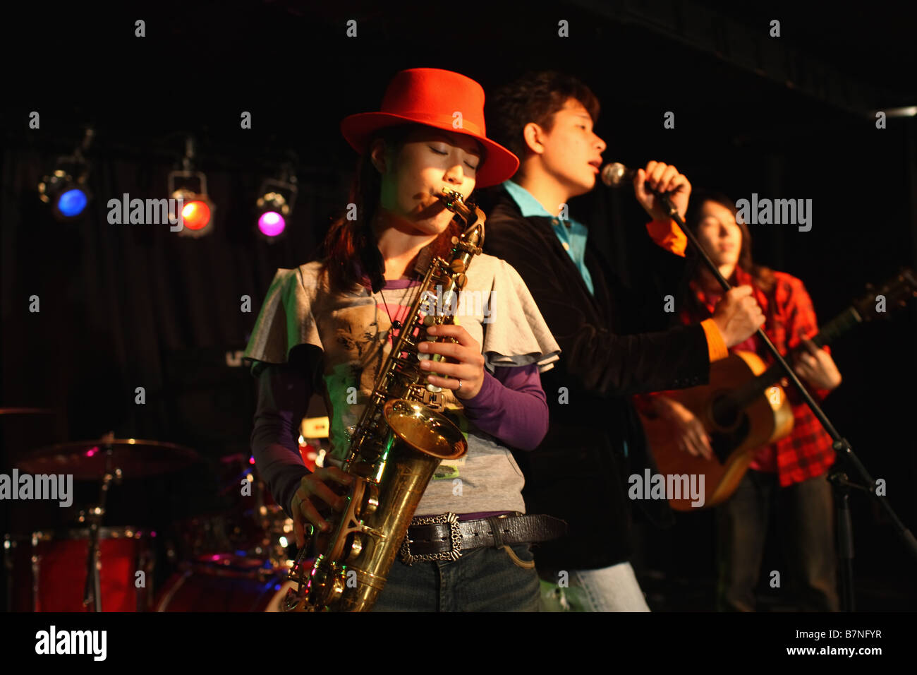 Young people playing instruments on the stage Stock Photo - Alamy
