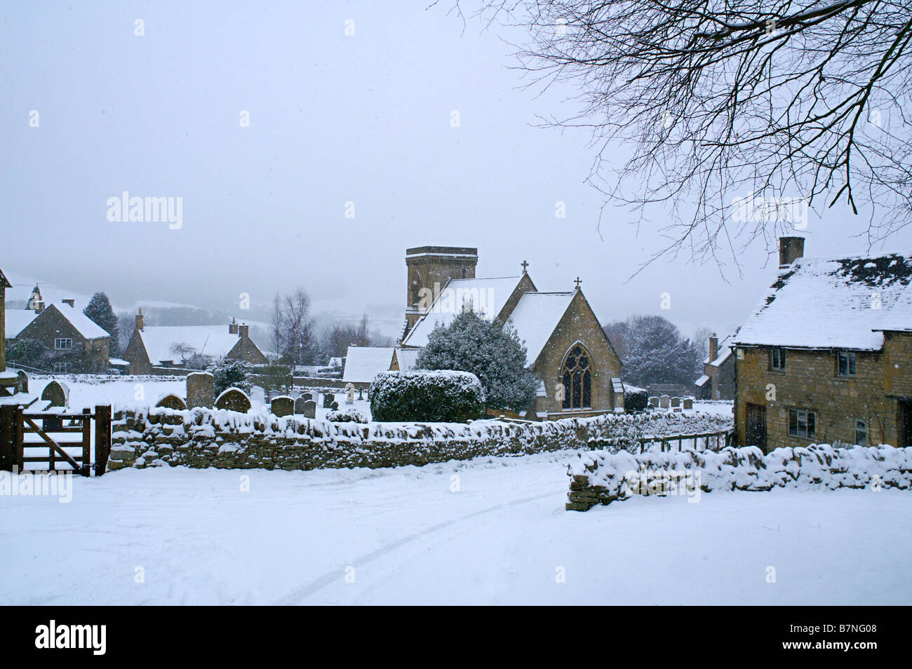 Houses and church covered with deep snow in Snowshill village. Winter ...