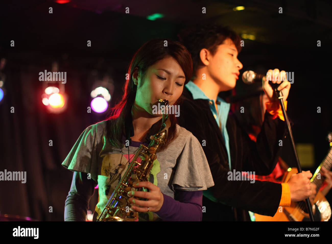 Young people playing instruments on the stage Stock Photo - Alamy