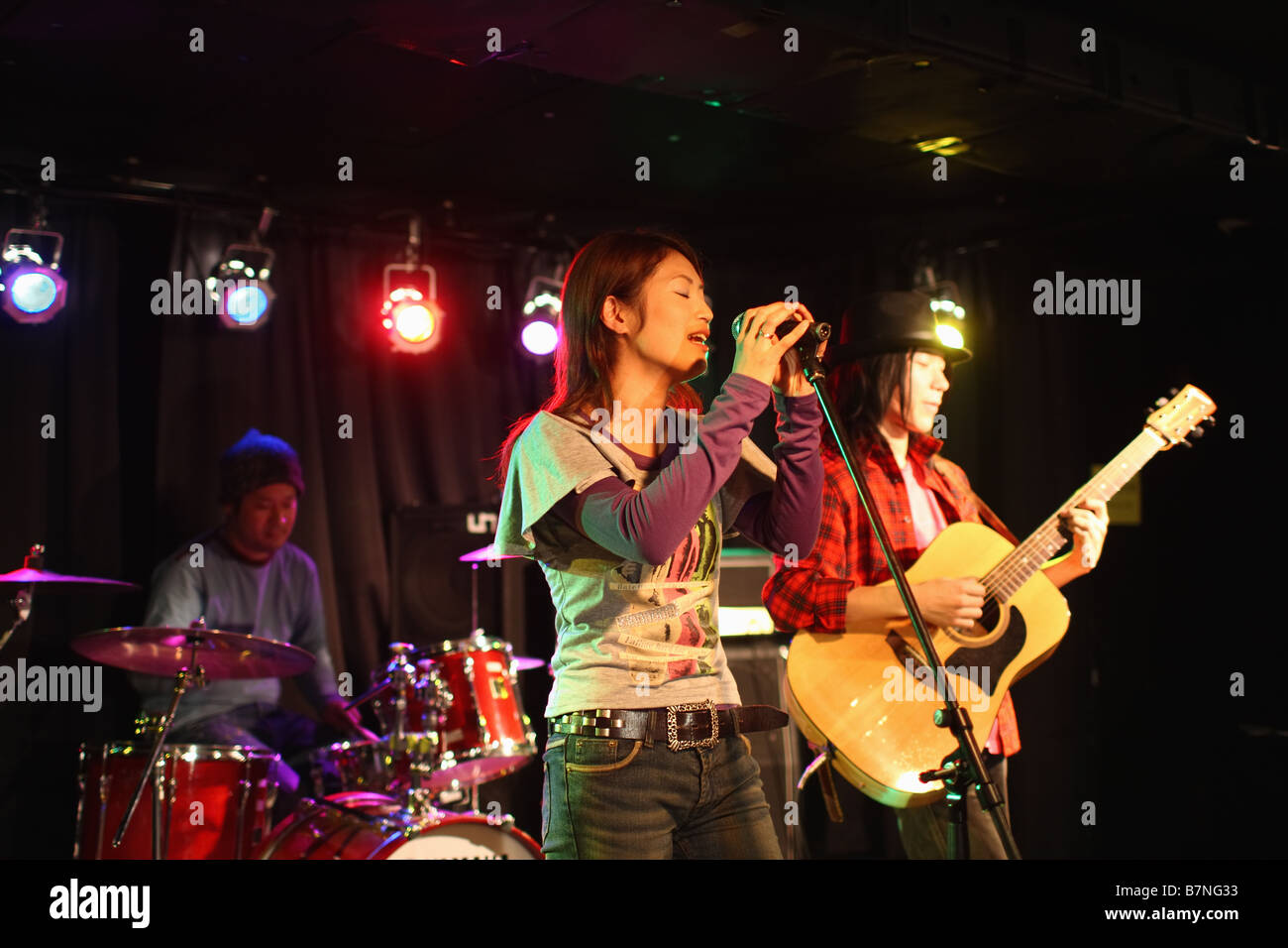 Young people playing instruments on the stage Stock Photo - Alamy