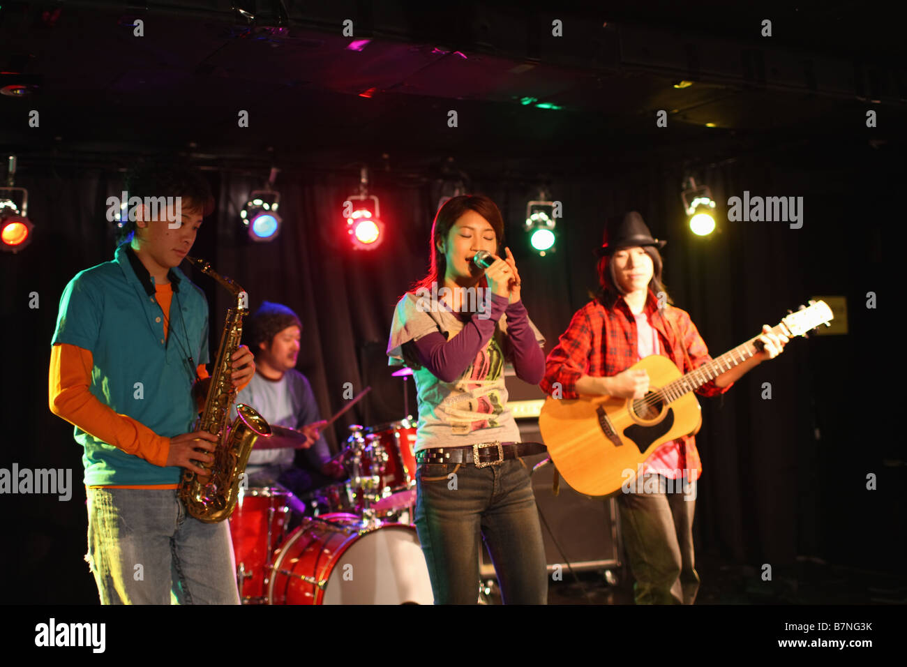 Young people playing instruments on the stage Stock Photo - Alamy