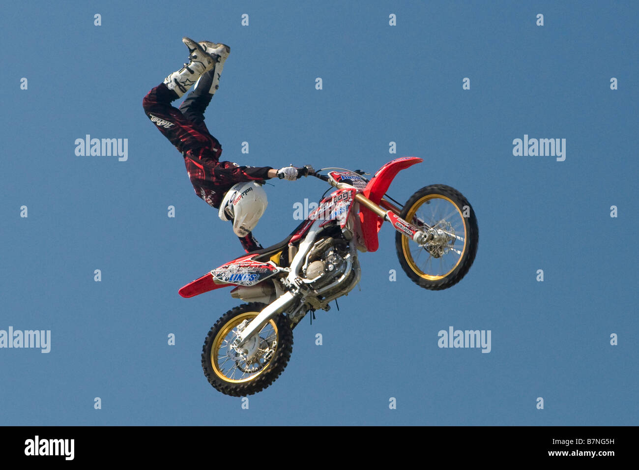 Motorbikes jumping over a ramp sky pictures Stock Photo - Alamy
