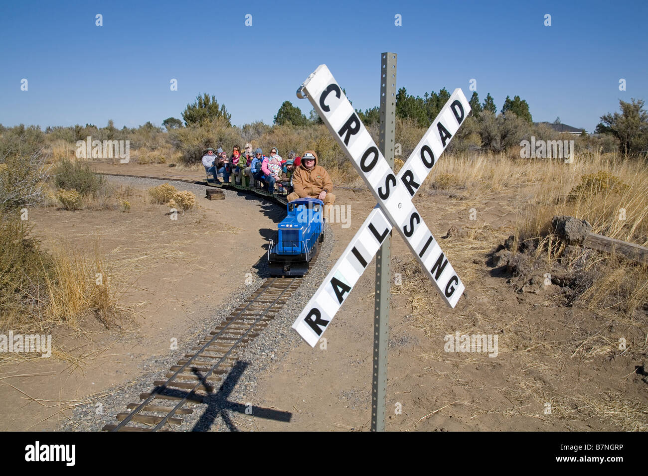 USA OREGON BEND Visitors to a small railroad museum ride miniature ...