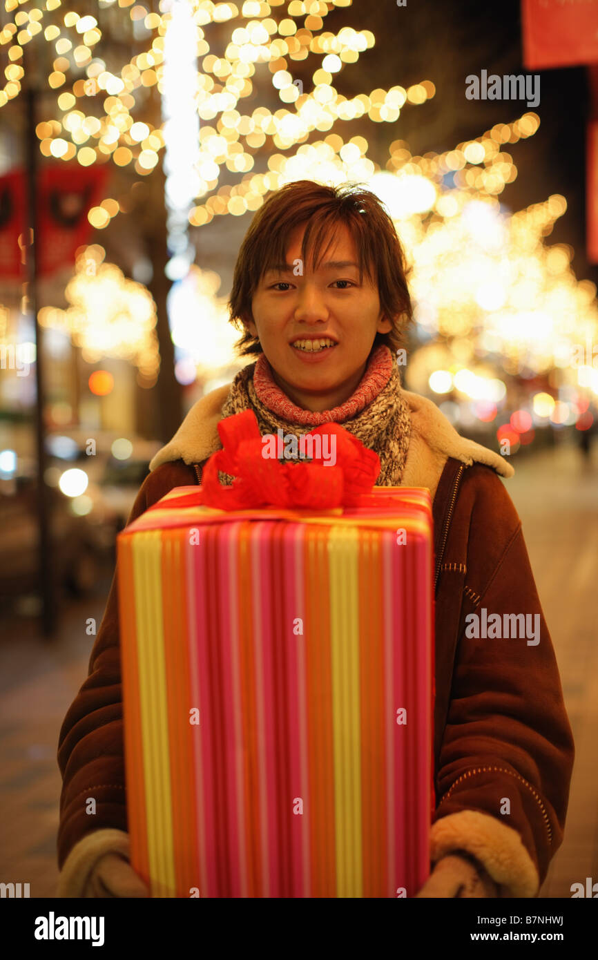 Man holding a present Stock Photo - Alamy