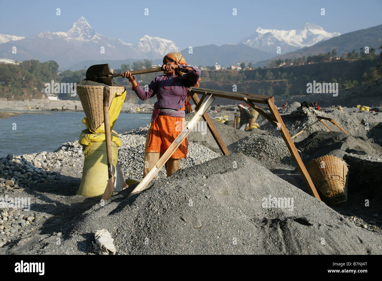 Woman working at a sand quarry Nepal Stock Photo - Alamy