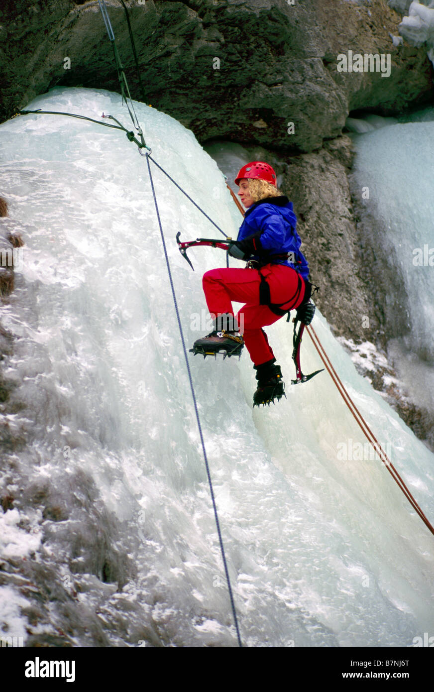Ice Climbing, Female Ice Climber learning to climb on Frozen Waterfall ...