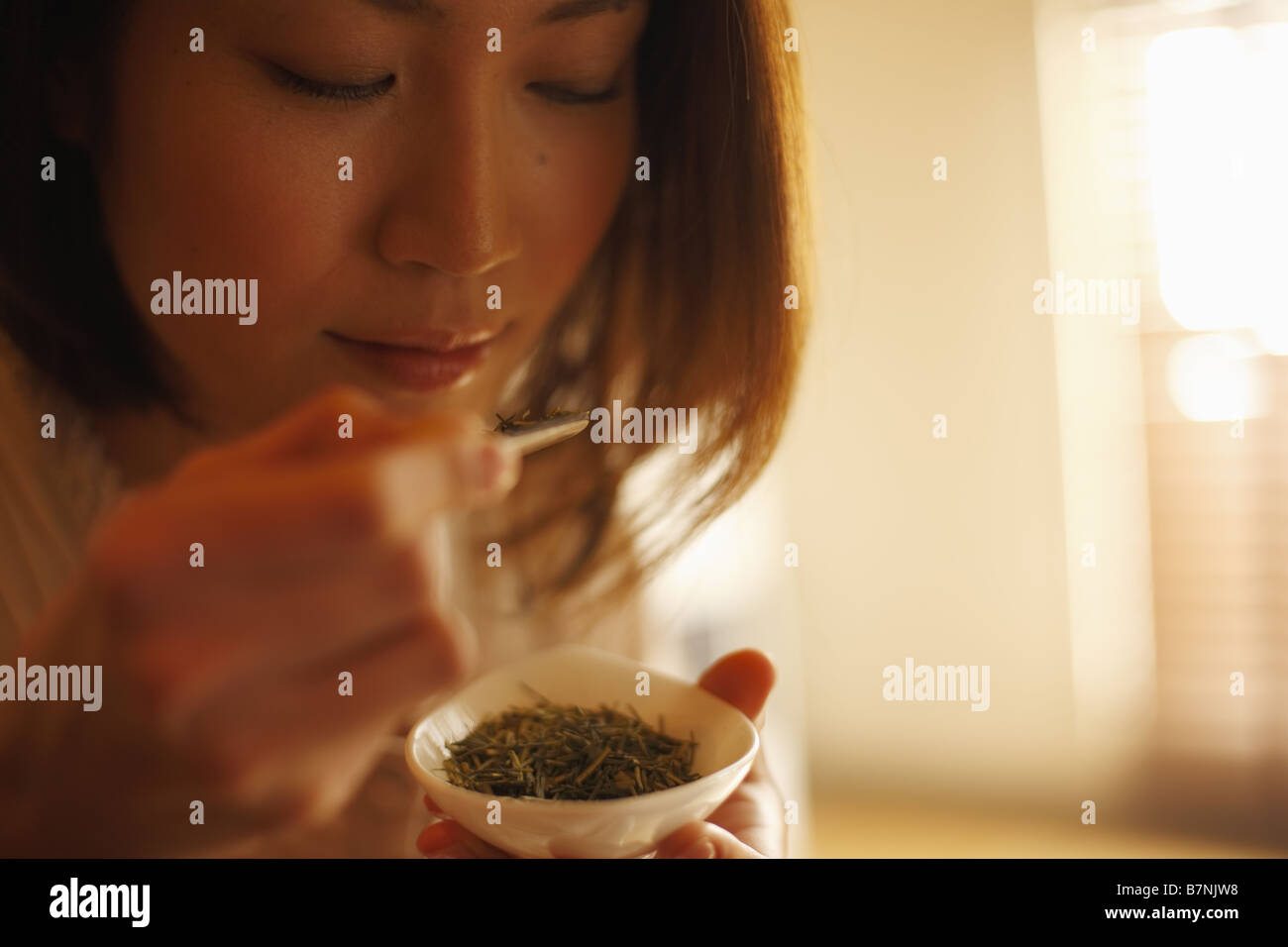 A woman smelling tea leaves Stock Photo - Alamy
