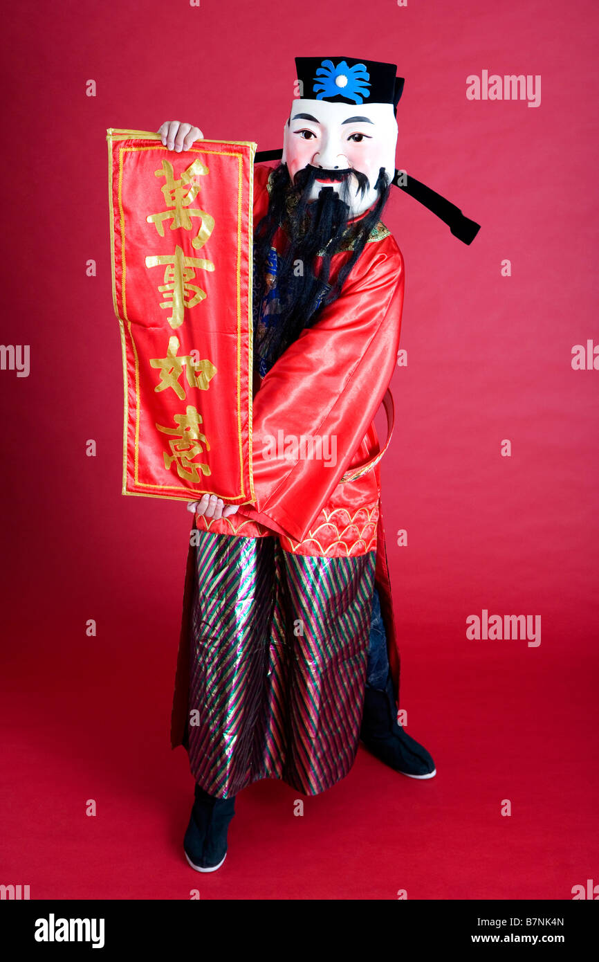 Young man in costume presenting Chinese luck poem Stock Photo - Alamy