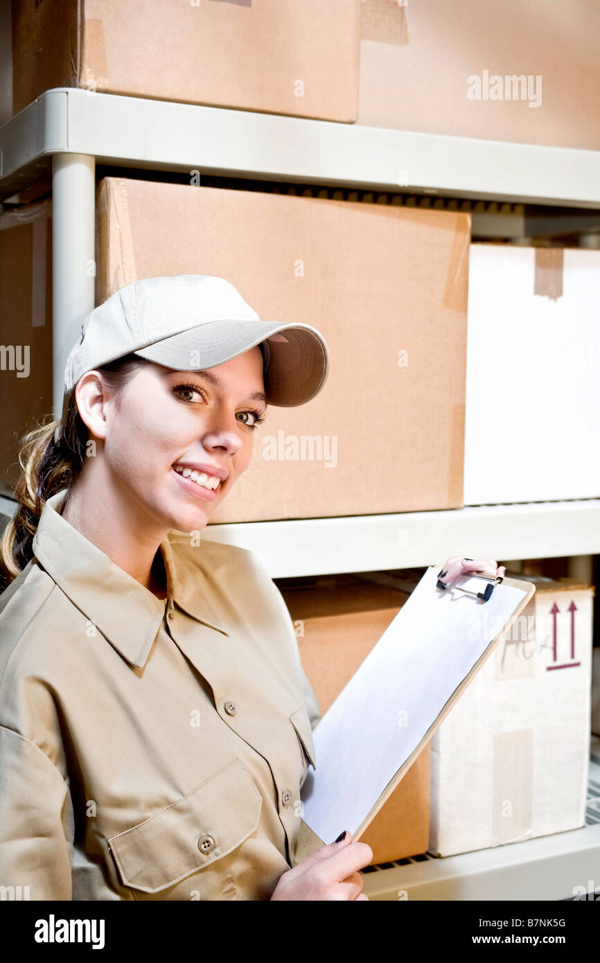 Woman taking inventory in warehouse hi-res stock photography and images - Alamy