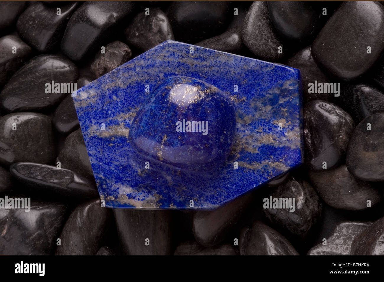 Lapis Lazuli polished mineral specimen on black riverstones Stock Photo ...