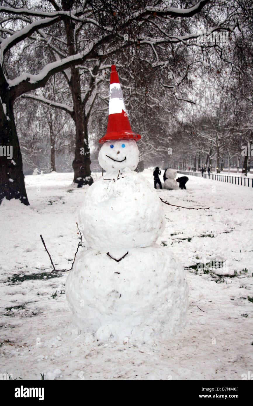 Snowman with a cone or traffic bollard on his head in St James Park ...