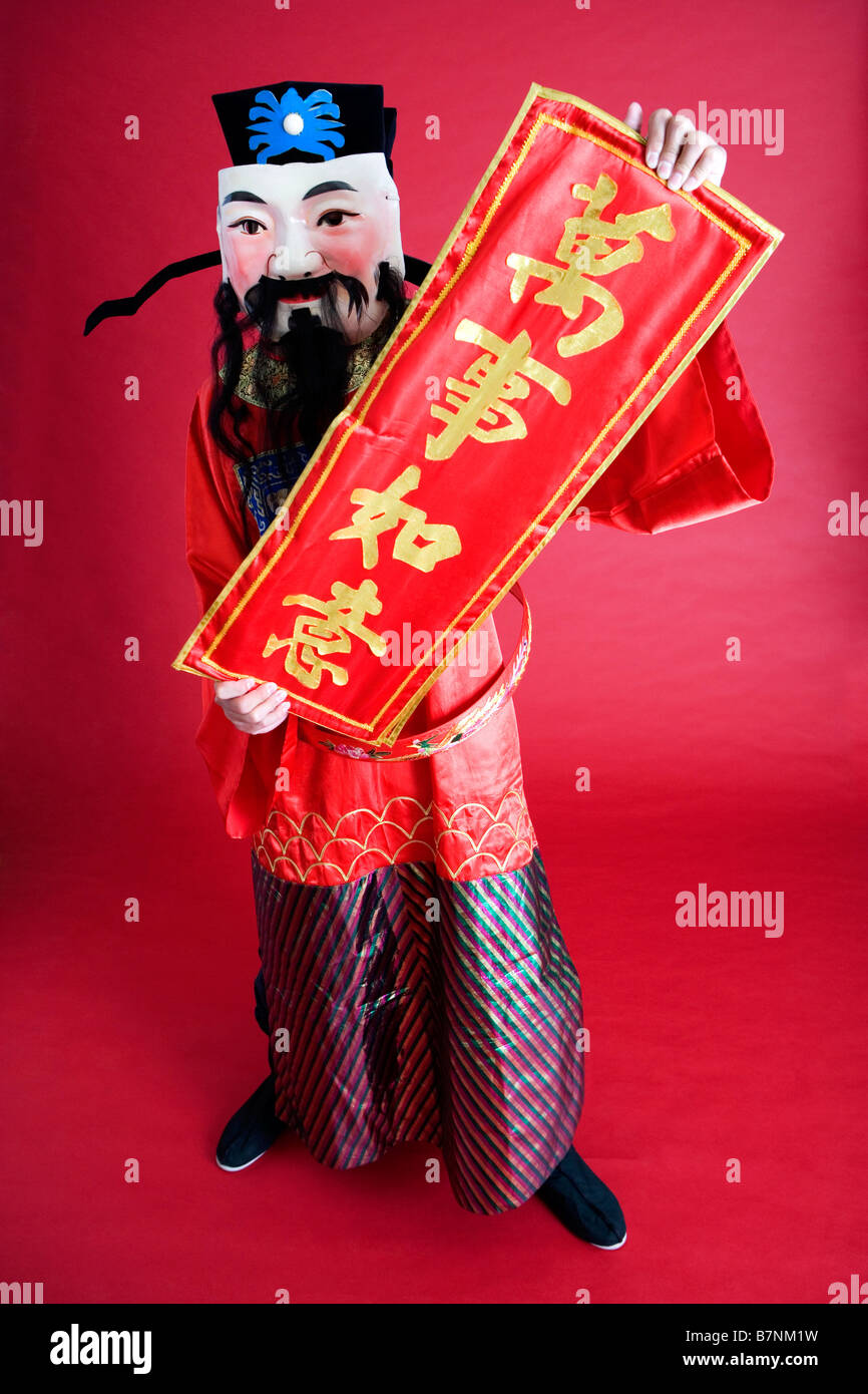 Young man in costume presenting Chinese luck poem Stock Photo - Alamy