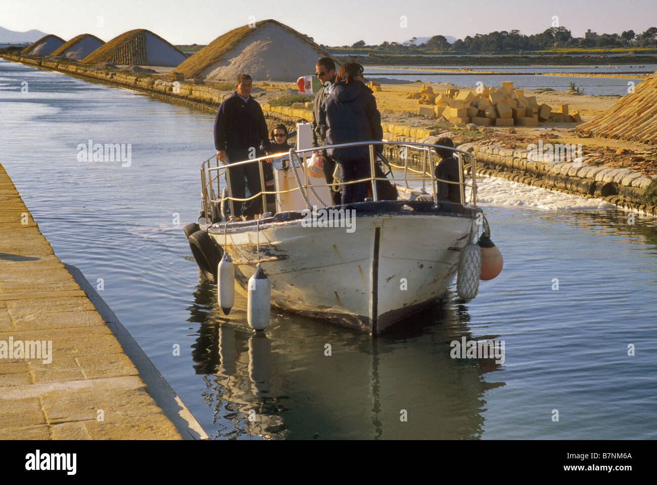 Tour boat in channel and salt mounds at Stagnone lagoon near Mozia or ...