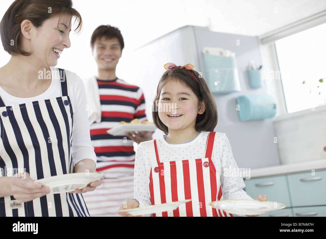 A girl helping parents Stock Photo - Alamy
