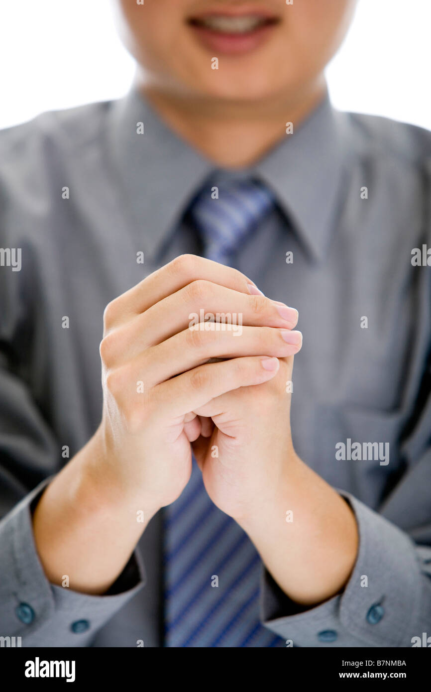 Man with hands clasped toward to camera Stock Photo - Alamy