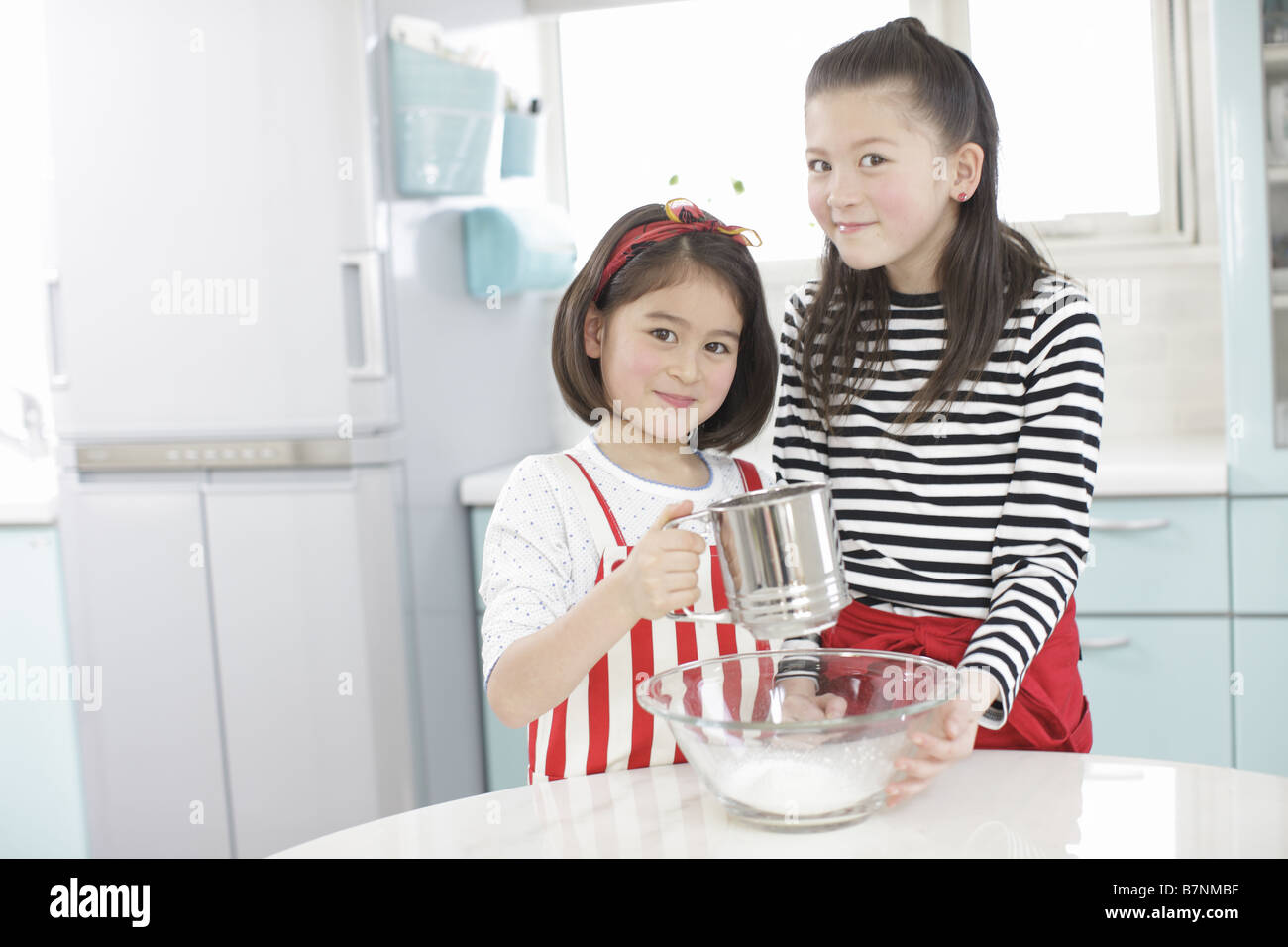 Girls making sweets Stock Photo - Alamy