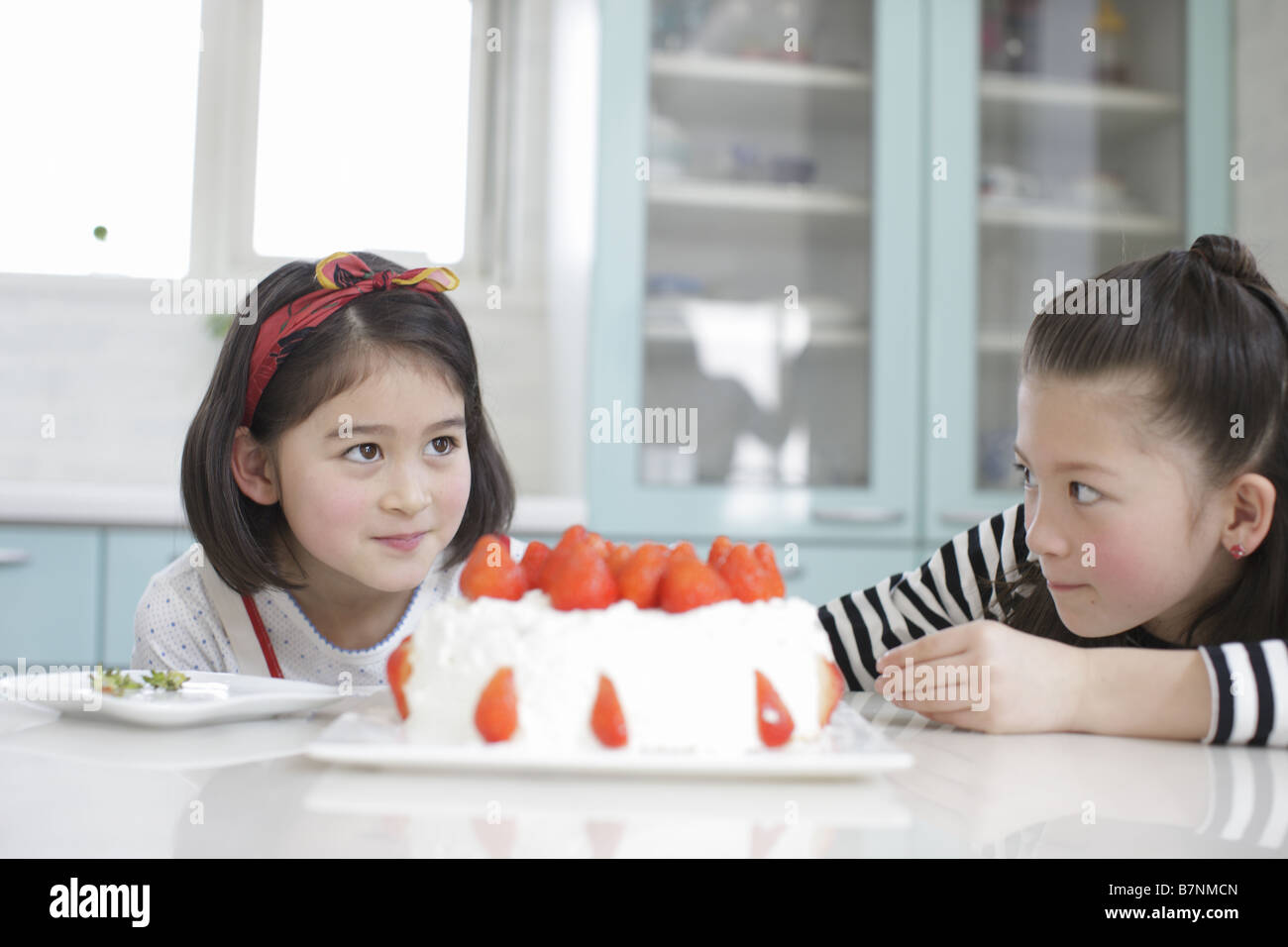 Girls and a cake Stock Photo - Alamy
