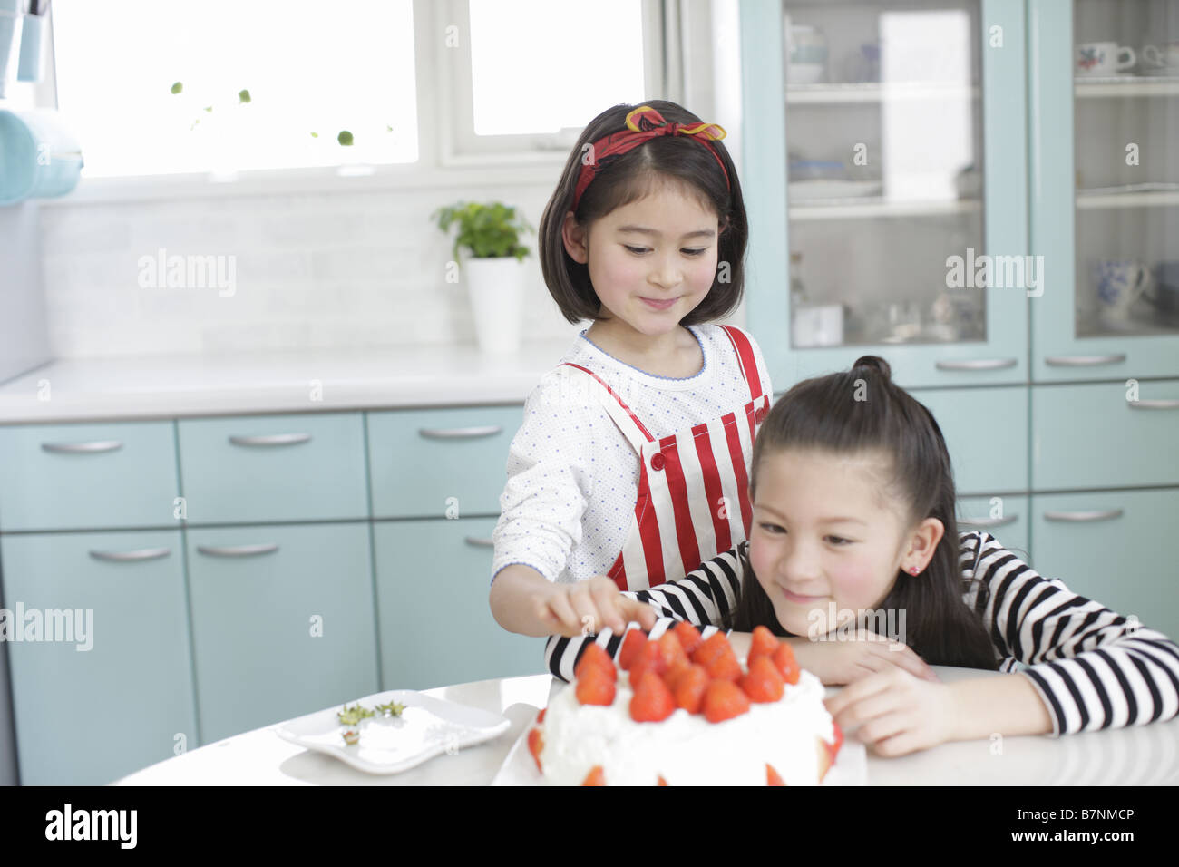 Girls and a cake Stock Photo - Alamy