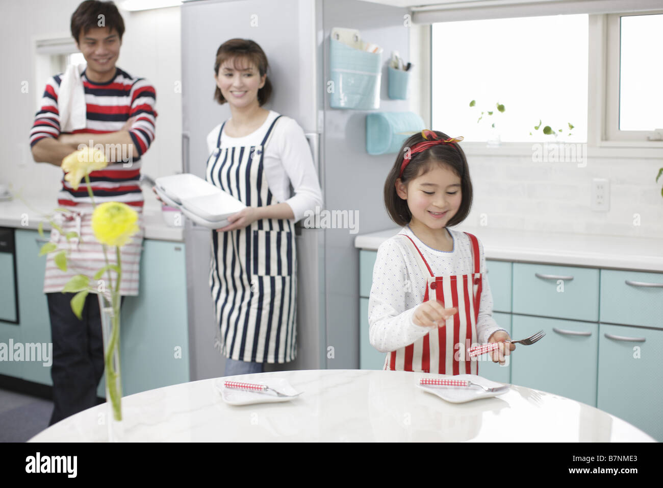 A girl helping parents Stock Photo - Alamy