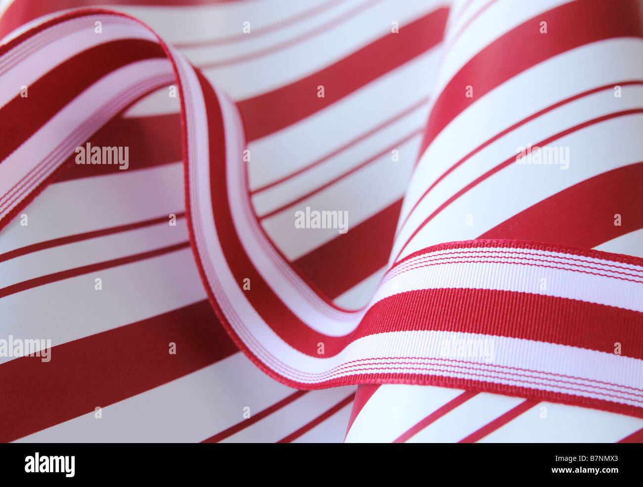 red and white ribbon curving on red and white paper Stock Photo - Alamy