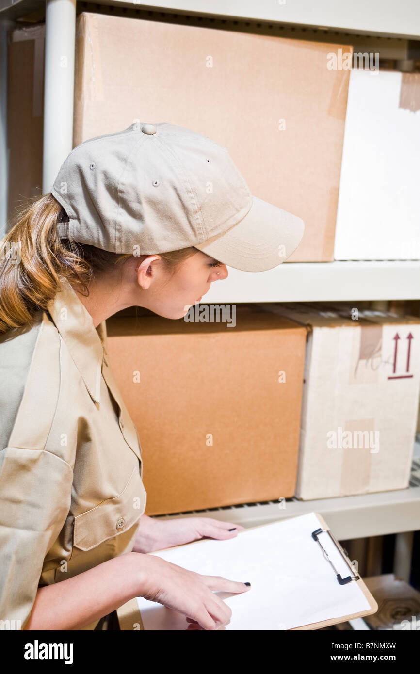 A young worker taking inventory in a warehouse Stock Photo - Alamy